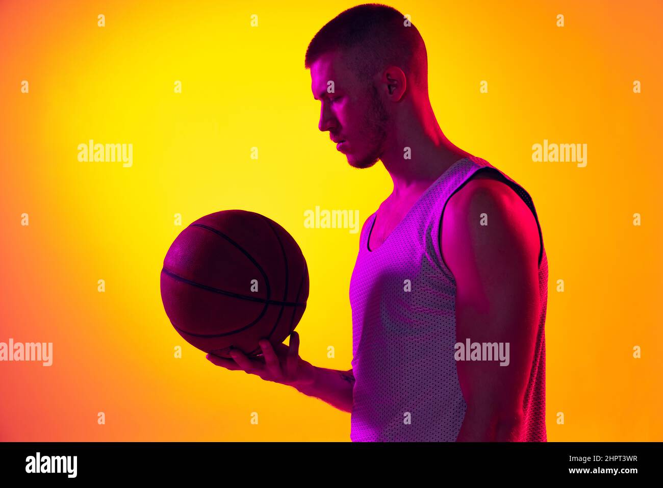 Studio shot of muscled man, basketball player, danker isolated on ...