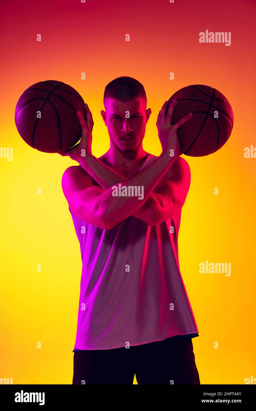 Studio shot of muscled man, basketball player, danker isolated on ...