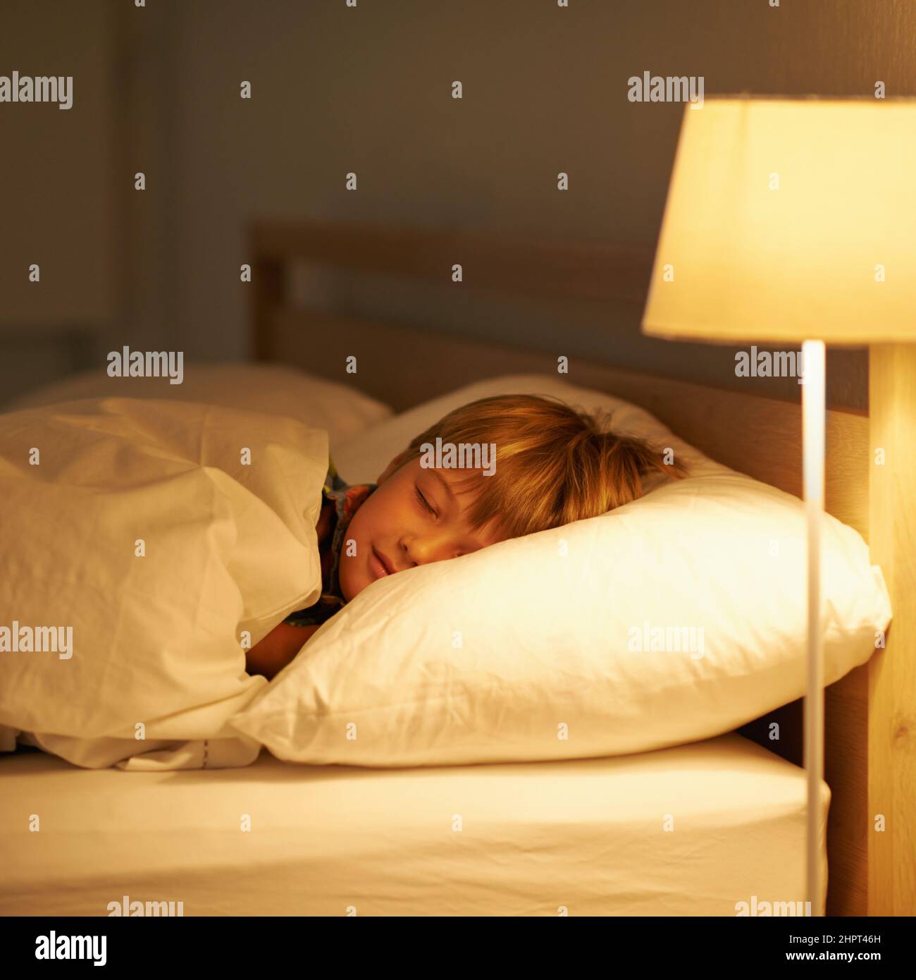 He always sleeps so peacefully. Shot of a young boy sleeping in bed ...