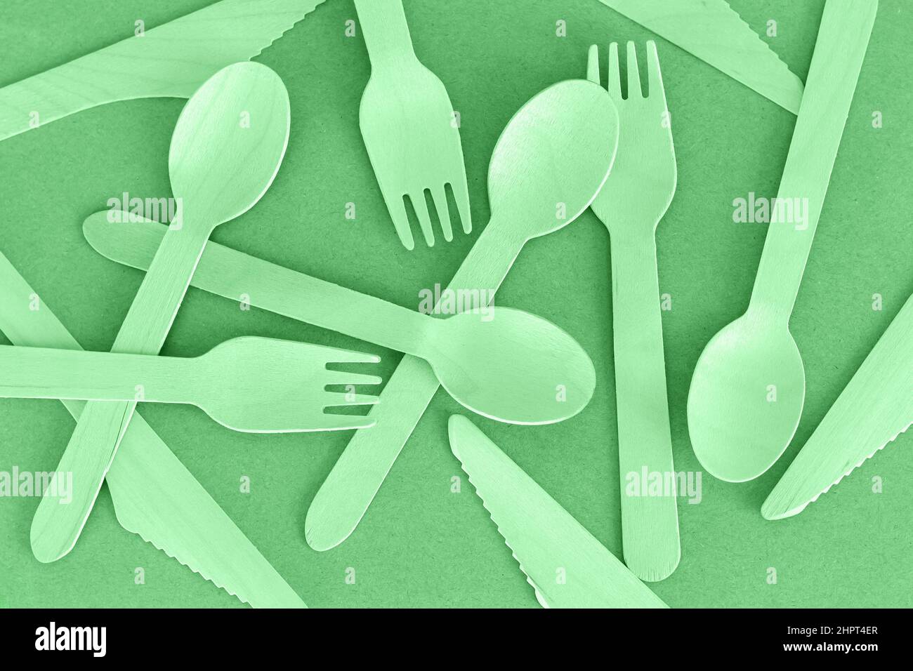 Set of eco green disposable wooden spoons, knives and forks top view ...