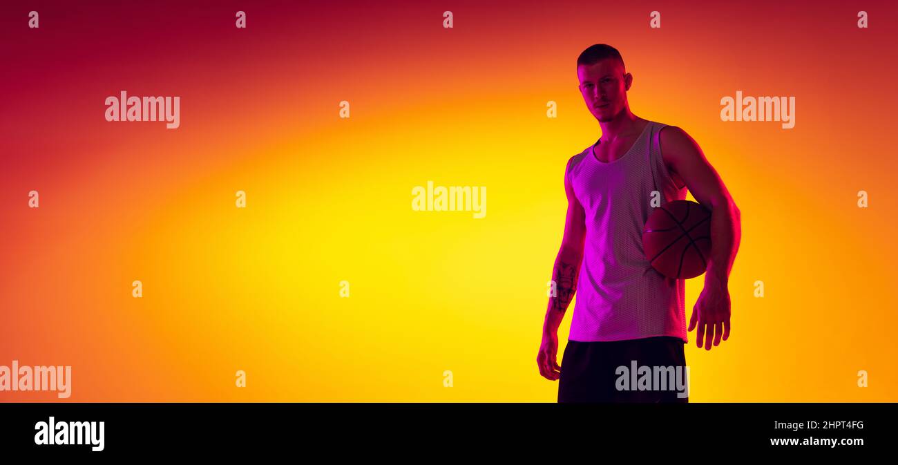 Studio shot of muscled man, basketball player, danker isolated on ...