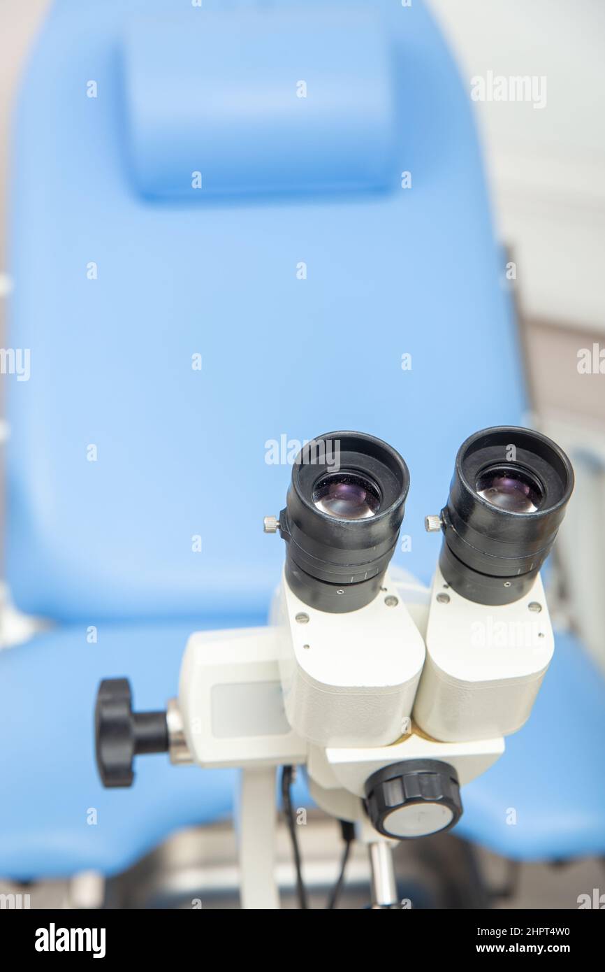 Colposcope closeup on the background of gynecological chair ...