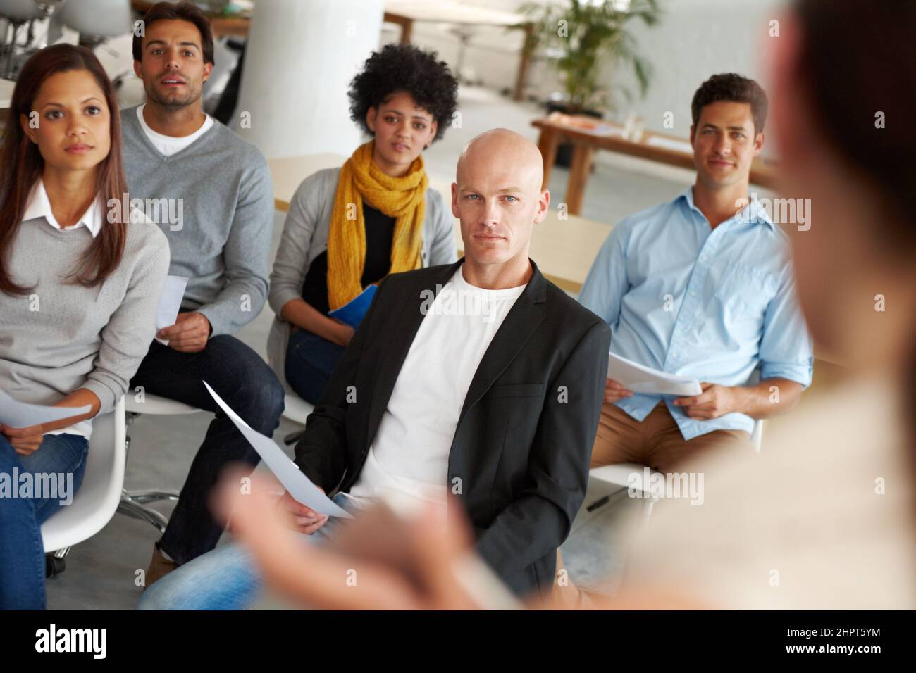 Giving their full attention. A group of colleagues sitting in a ...