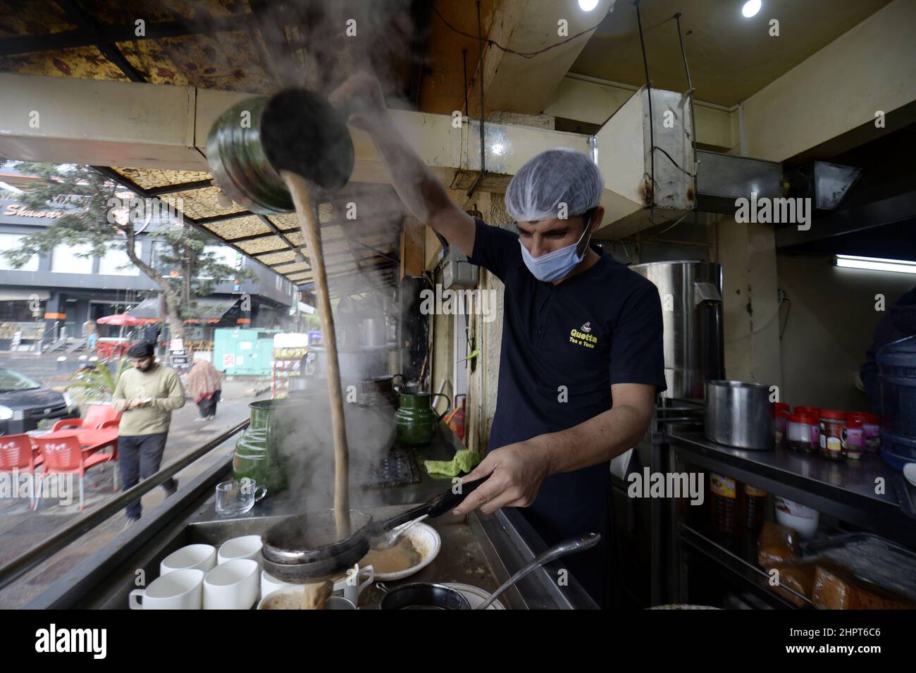 Islamabad, Pakistan. 23rd Feb, 2022. A man makes milk tea at a milk tea ...