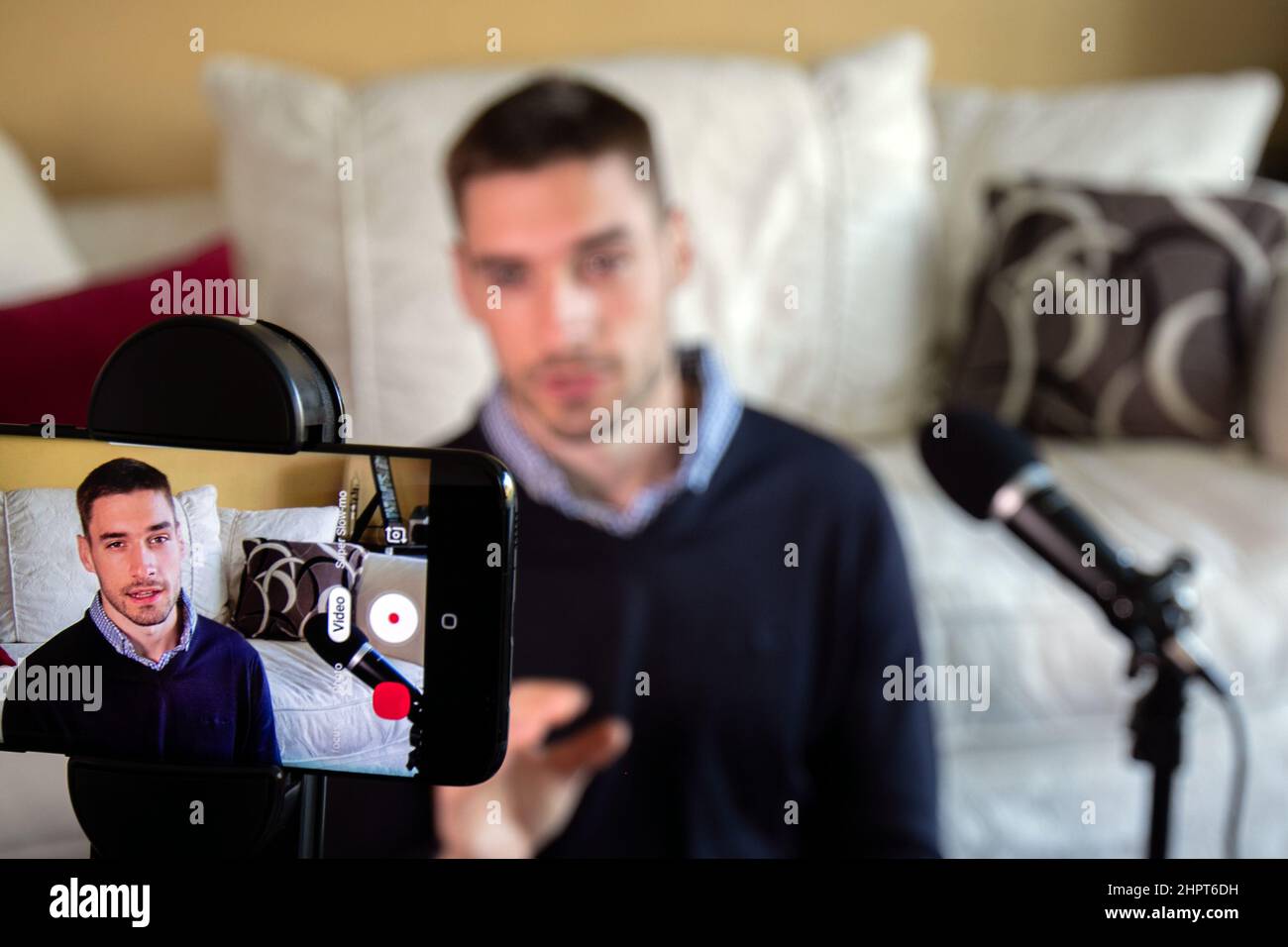 Young male vlogging video broadcast from home studio setup Stock Photo ...