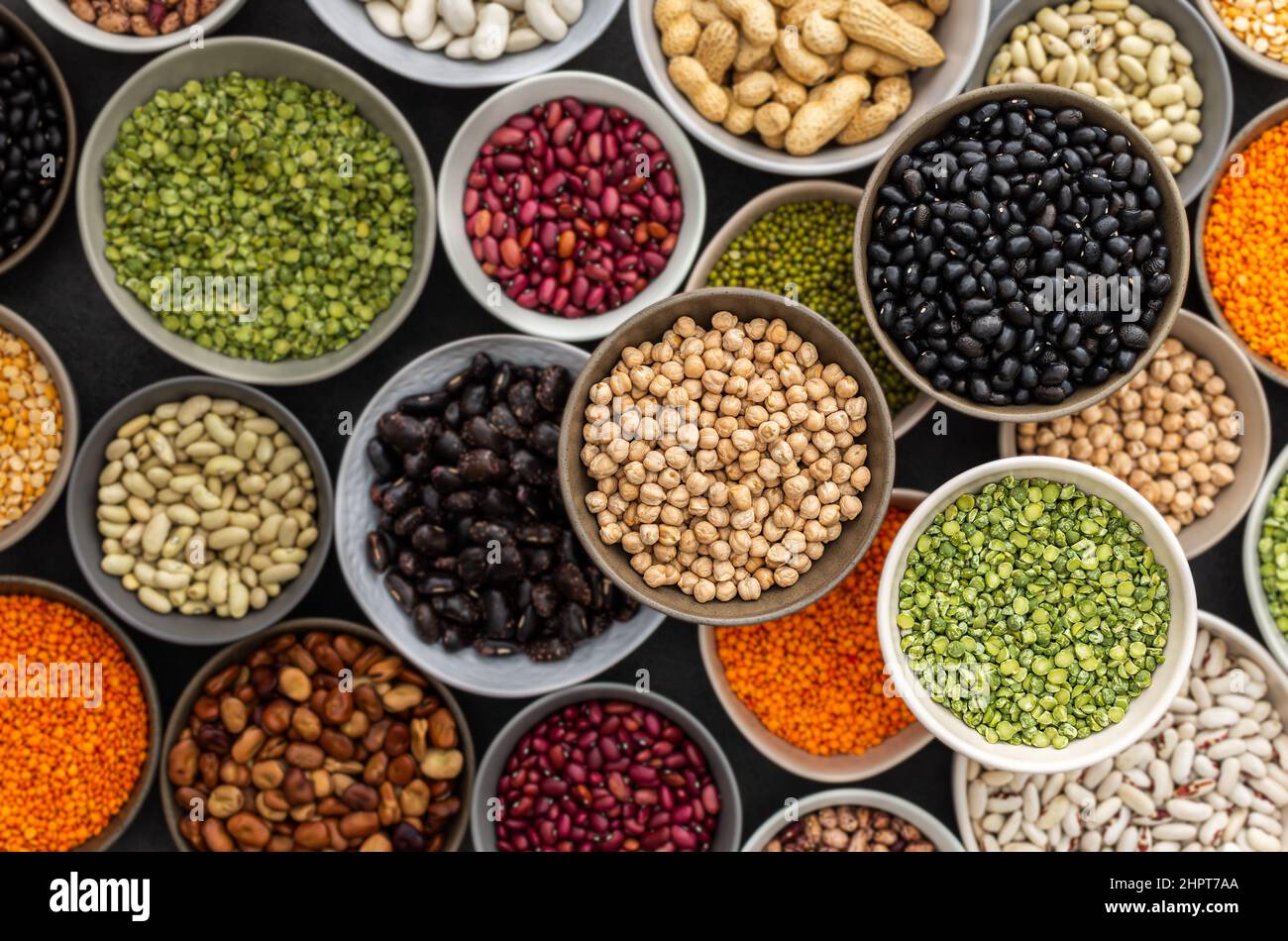 Different types of legumes in bowls, green with yellow peas and mung ...
