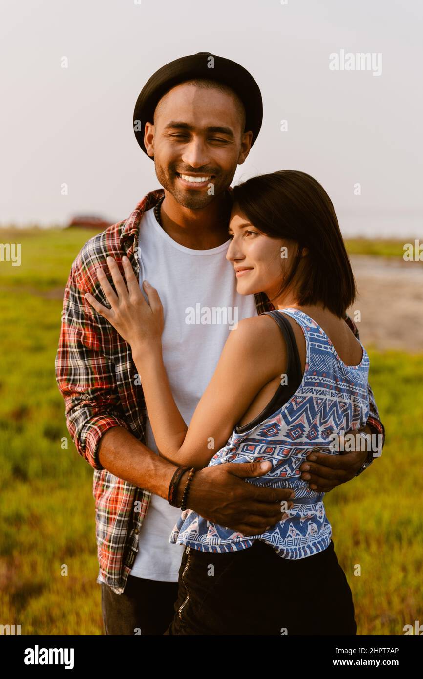 Young multiracial couple smiling and hugging together outdoors Stock ...