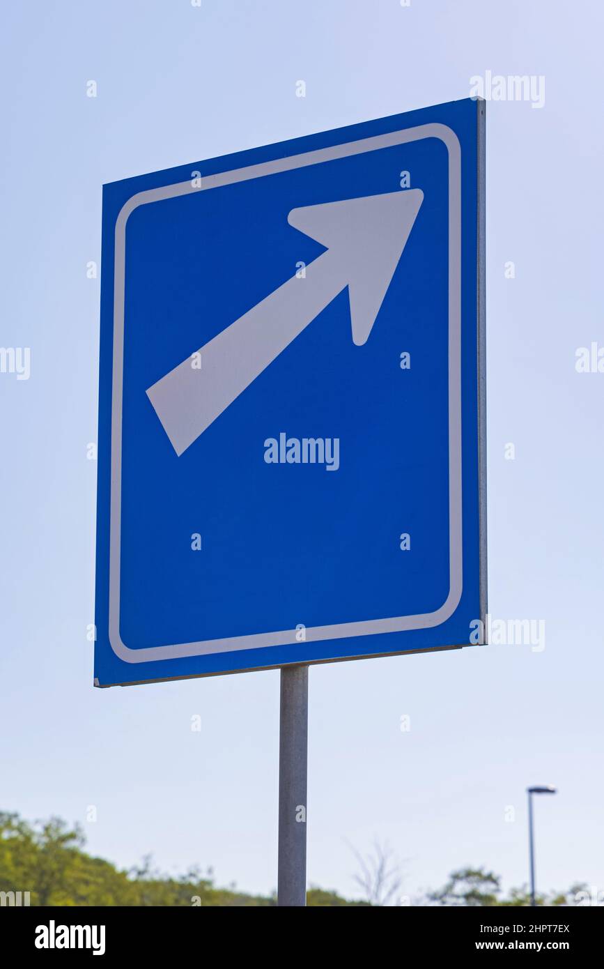 Highway Exit Arrow at Blue Traffic Sign Stock Photo - Alamy