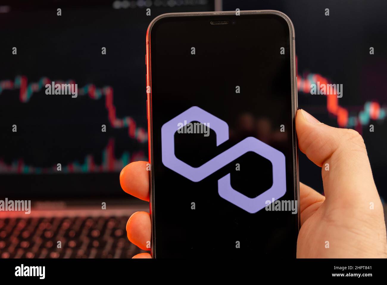 Polygon MATIC cryptocurrency logo on the screen of smartphone in mans ...