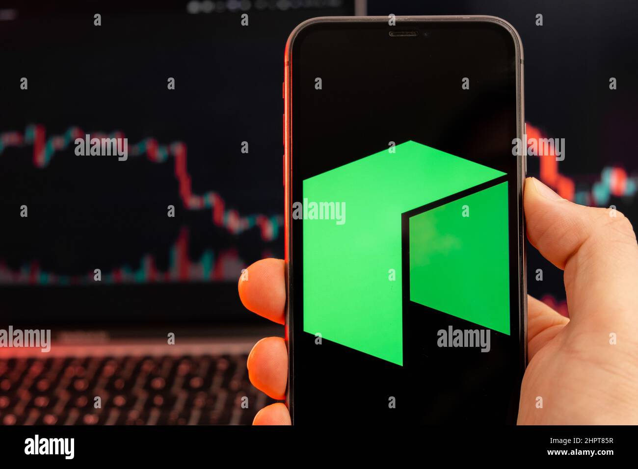 Neo NEO cryptocurrency logo on the screen of smartphone in mans hand ...