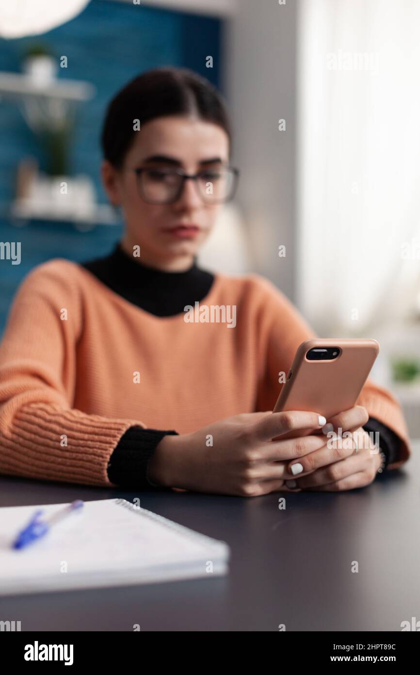 Content creator holding smartphone looking at content on screen ...