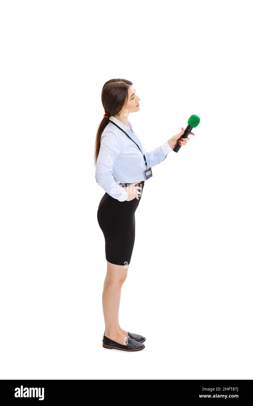 Side view of young beautiful girl, female journalist holding reporter ...
