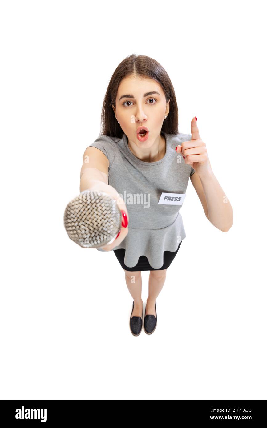 High angle view of emotional young girl, female journalist holding ...