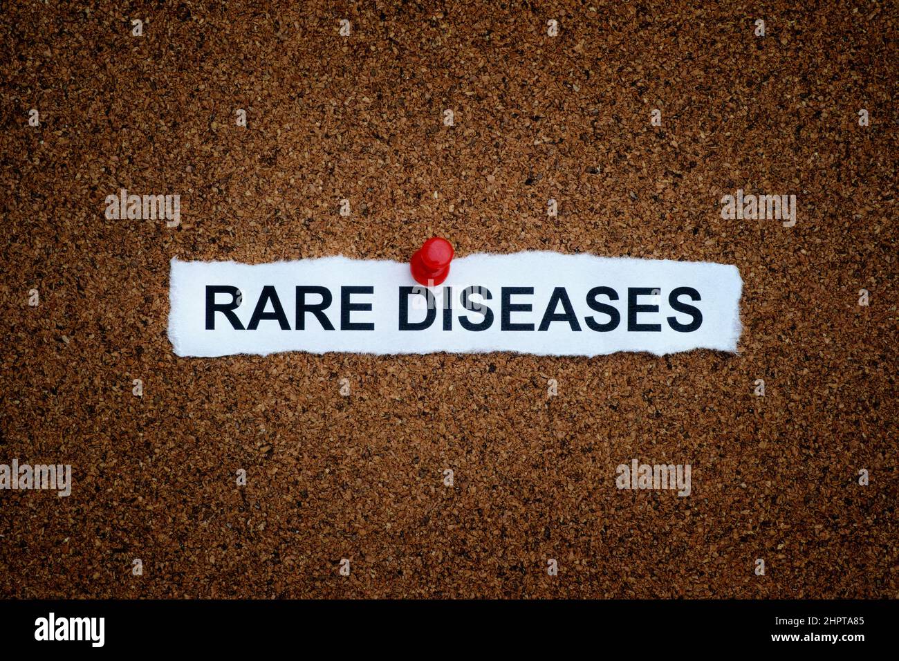 A crumpled piece of paper with the words Rare diseases on it pinned to ...