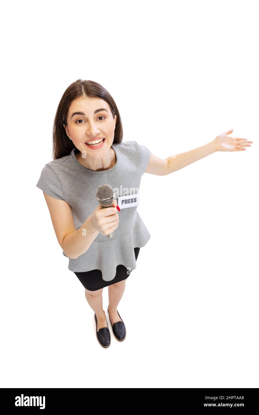 High angle view of emotional young girl, female journalist holding ...