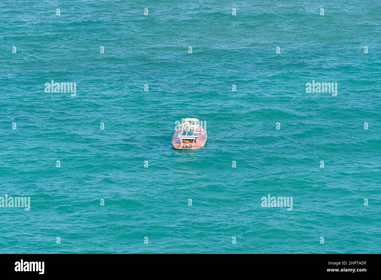 Small white and orange raft lost in the middle of the sea, with no ...
