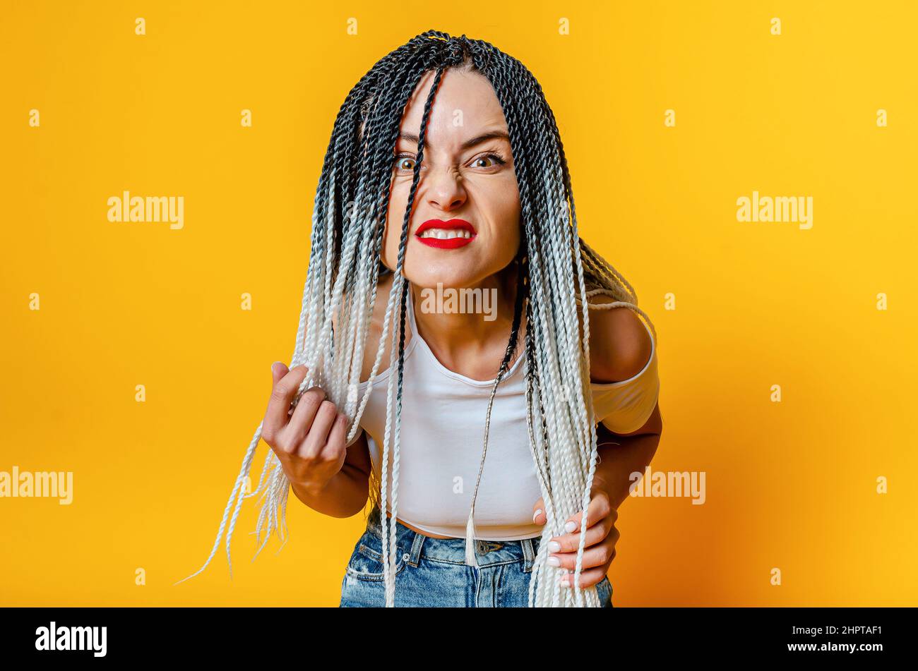 Portrait of angry woman with dreadlocks. Hands holding dreadlocks ...