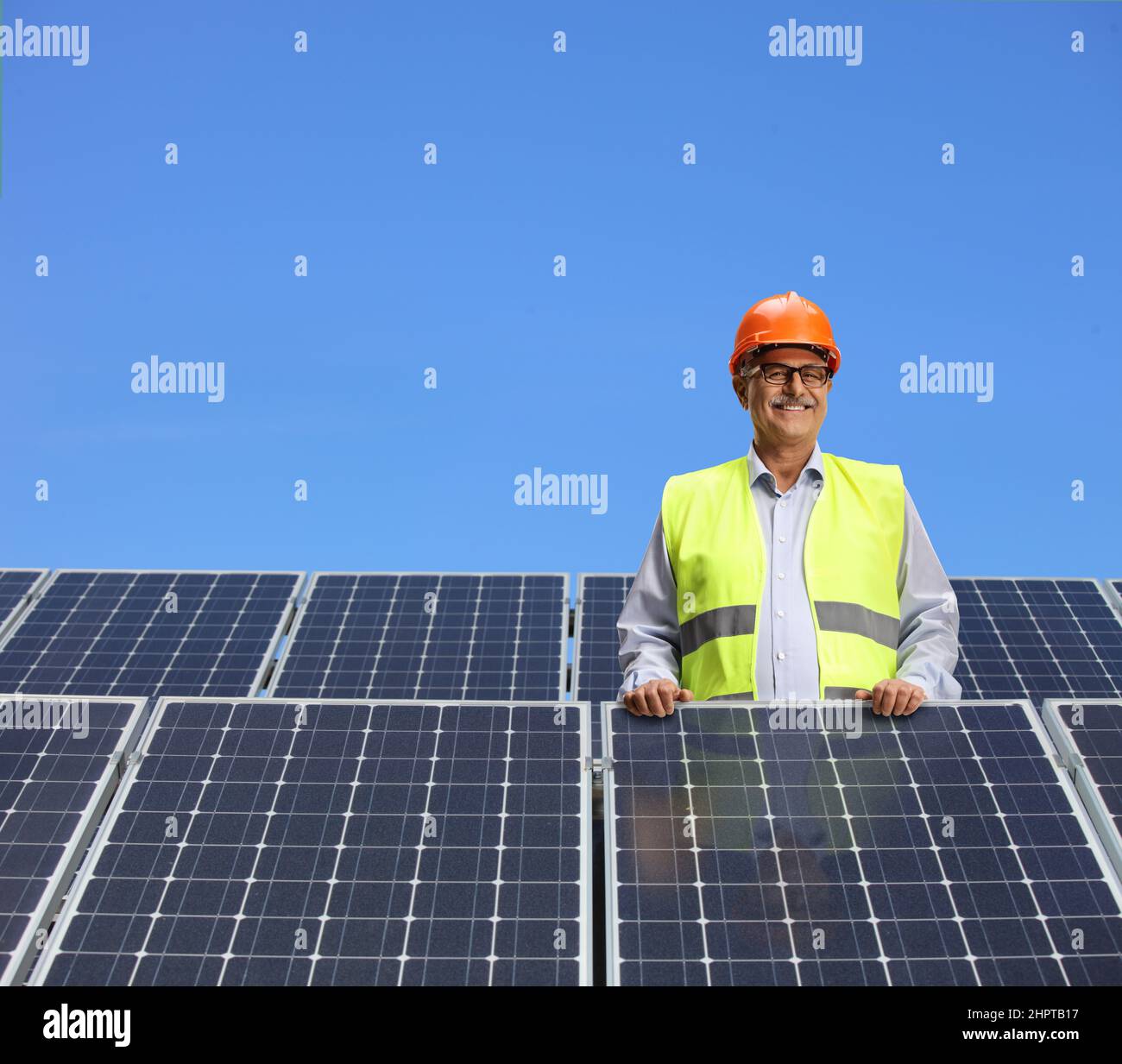 Worker solar power station smiling hi-res stock photography and images ...