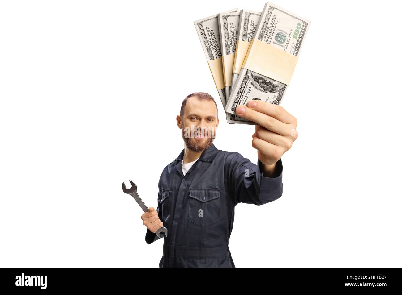 Mechanic in a uniform holding a wrench and money isolated on white ...