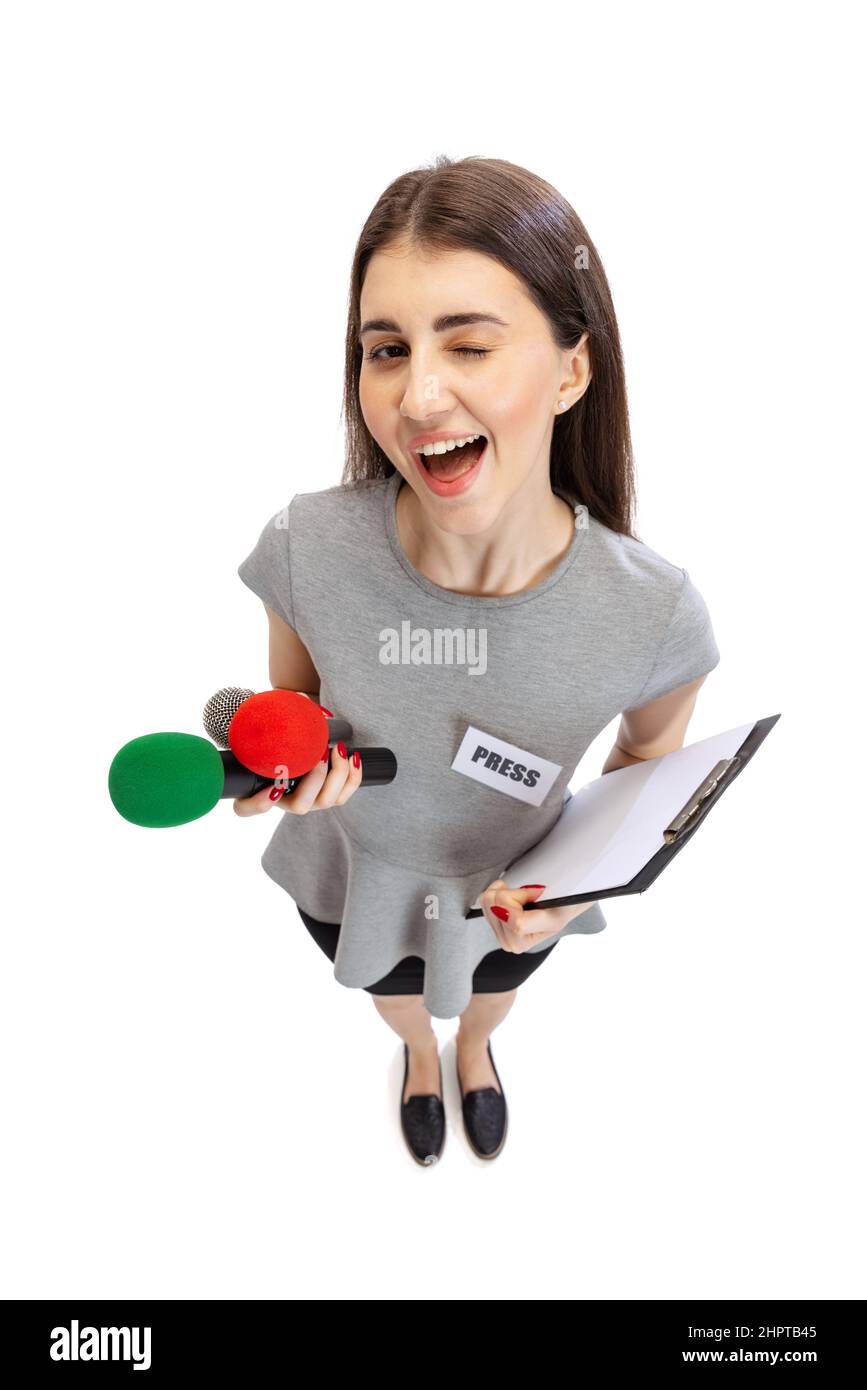 High angle view of emotional young girl, female journalist holding ...