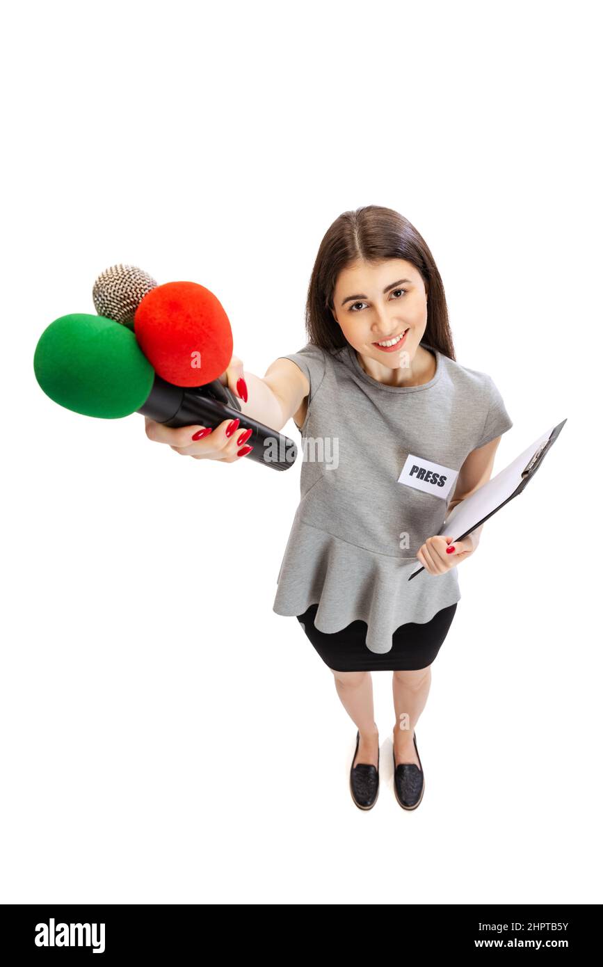 High angle view of emotional young girl, female journalist holding ...