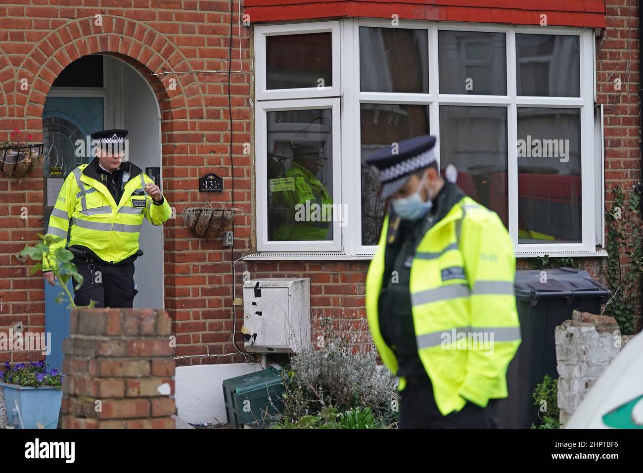 Police officers at the scene of a house fire on Windsor Road, Ilford ...