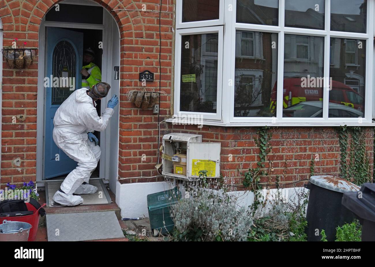 A forensic officer at the scene of a house fire on Windsor Road, Ilford ...