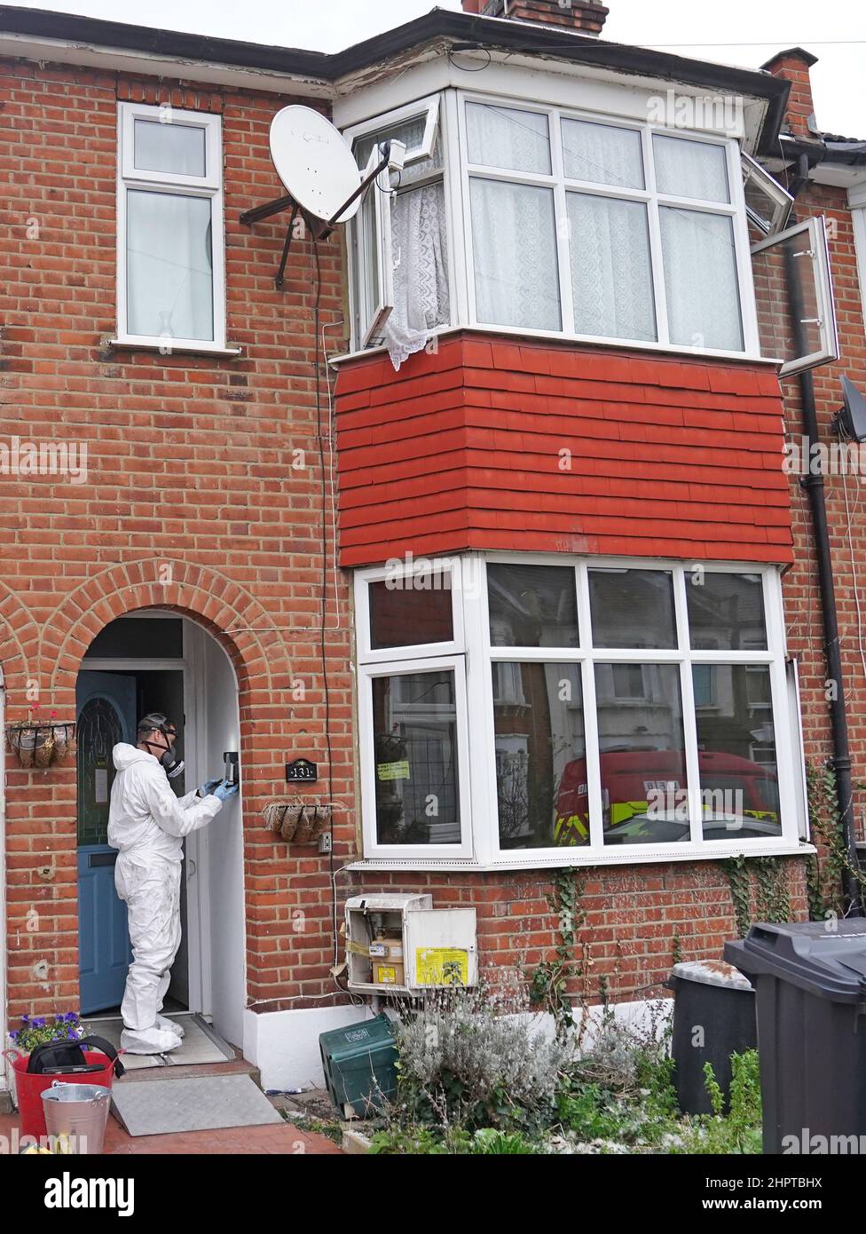 A forensic officer at the scene of a house fire on Windsor Road, Ilford ...