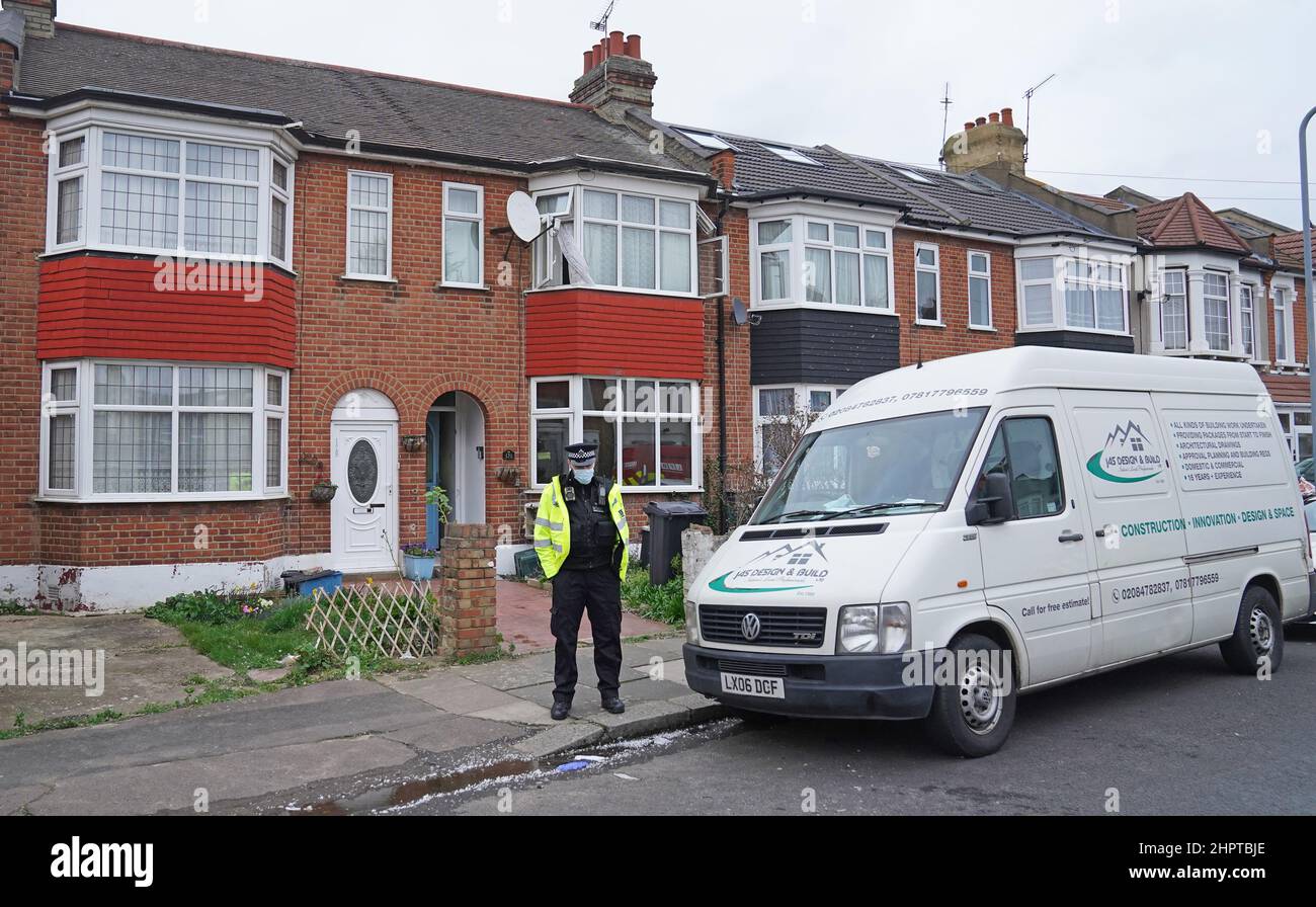 A police officer at the scene of a house fire on Windsor Road, Ilford ...