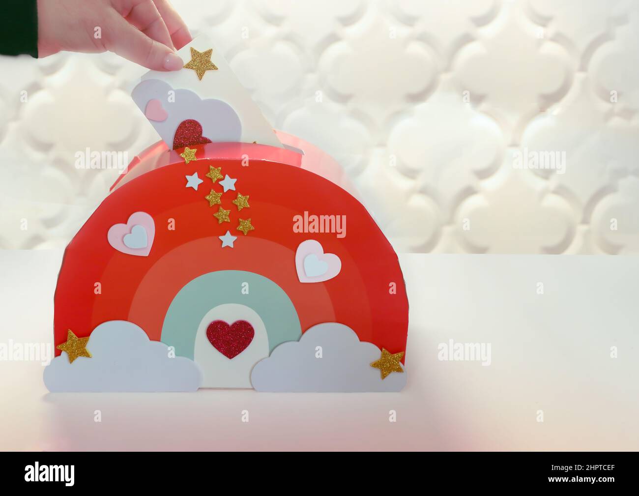 Closeup shot of the hand dropping the letter into mailbox for kids ...