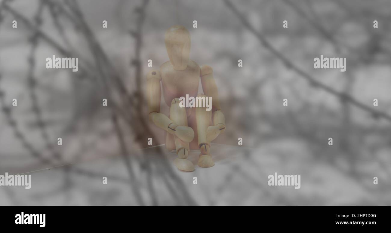 Image of barbed wire over sitting wooden puppet Stock Photo - Alamy