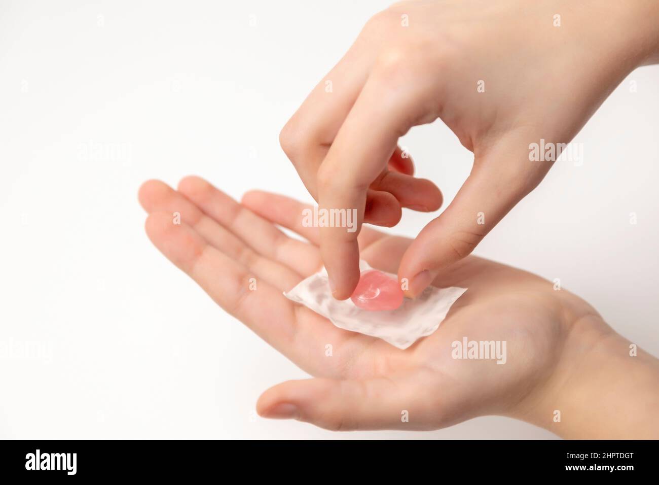 Children's hands open a pink lollipop on the palm Stock Photo - Alamy