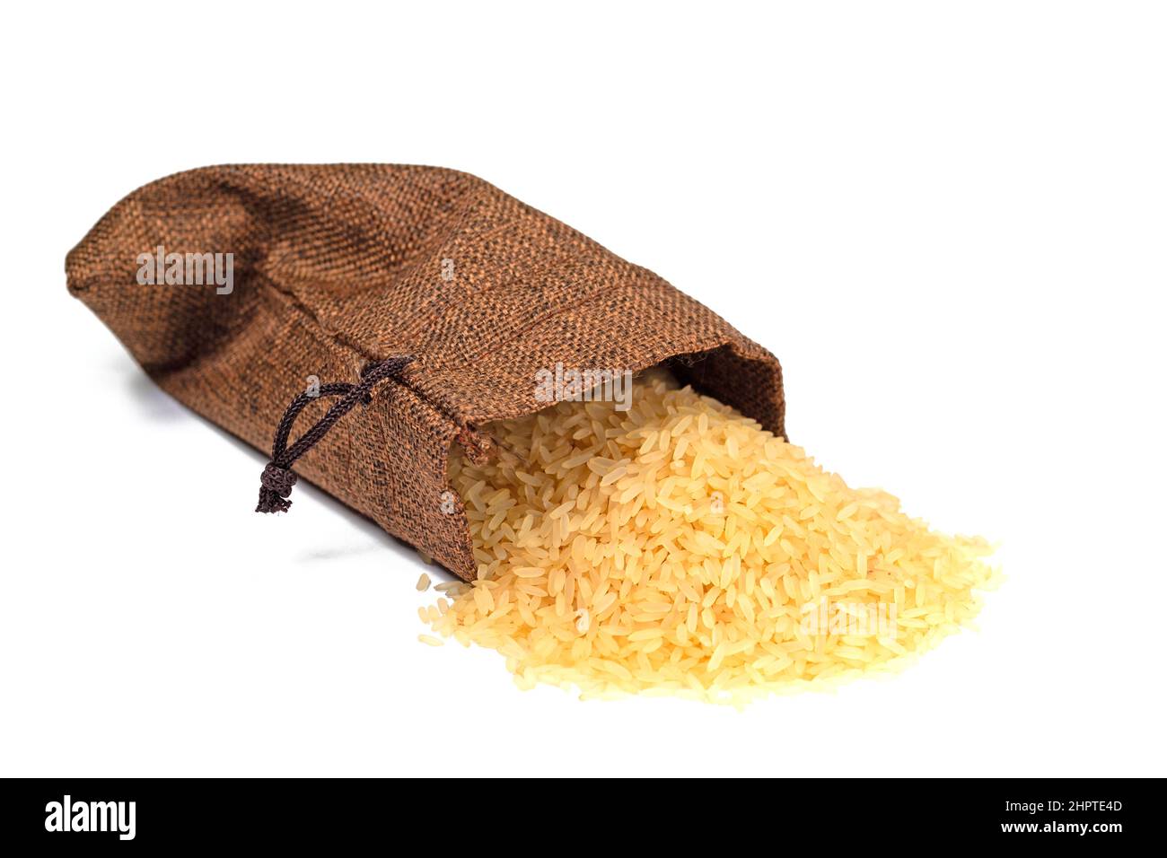Rice grains in jute sack against white background Stock Photo - Alamy