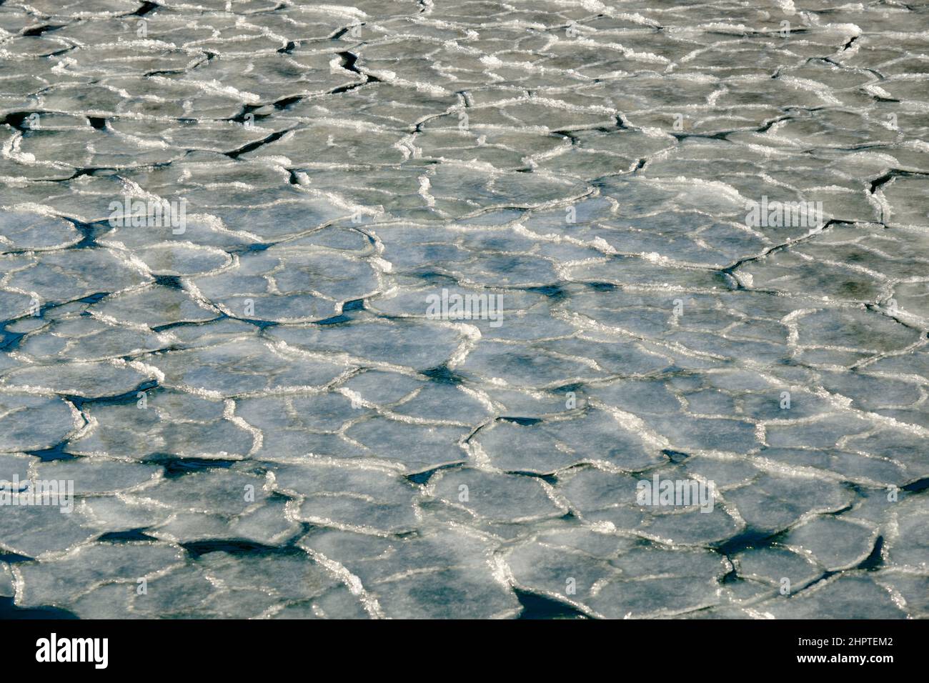 Abstract ice pattern on top of lake with geometric shapes created by ...