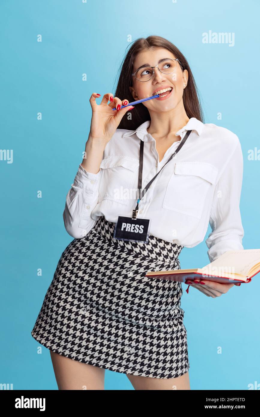 Portrait of young beautiful girl, female journalist with pen and diary ...