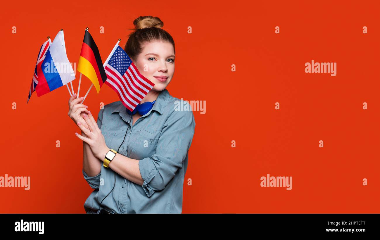 Caucasian student girl holds set small flags. Study abroad concept ...