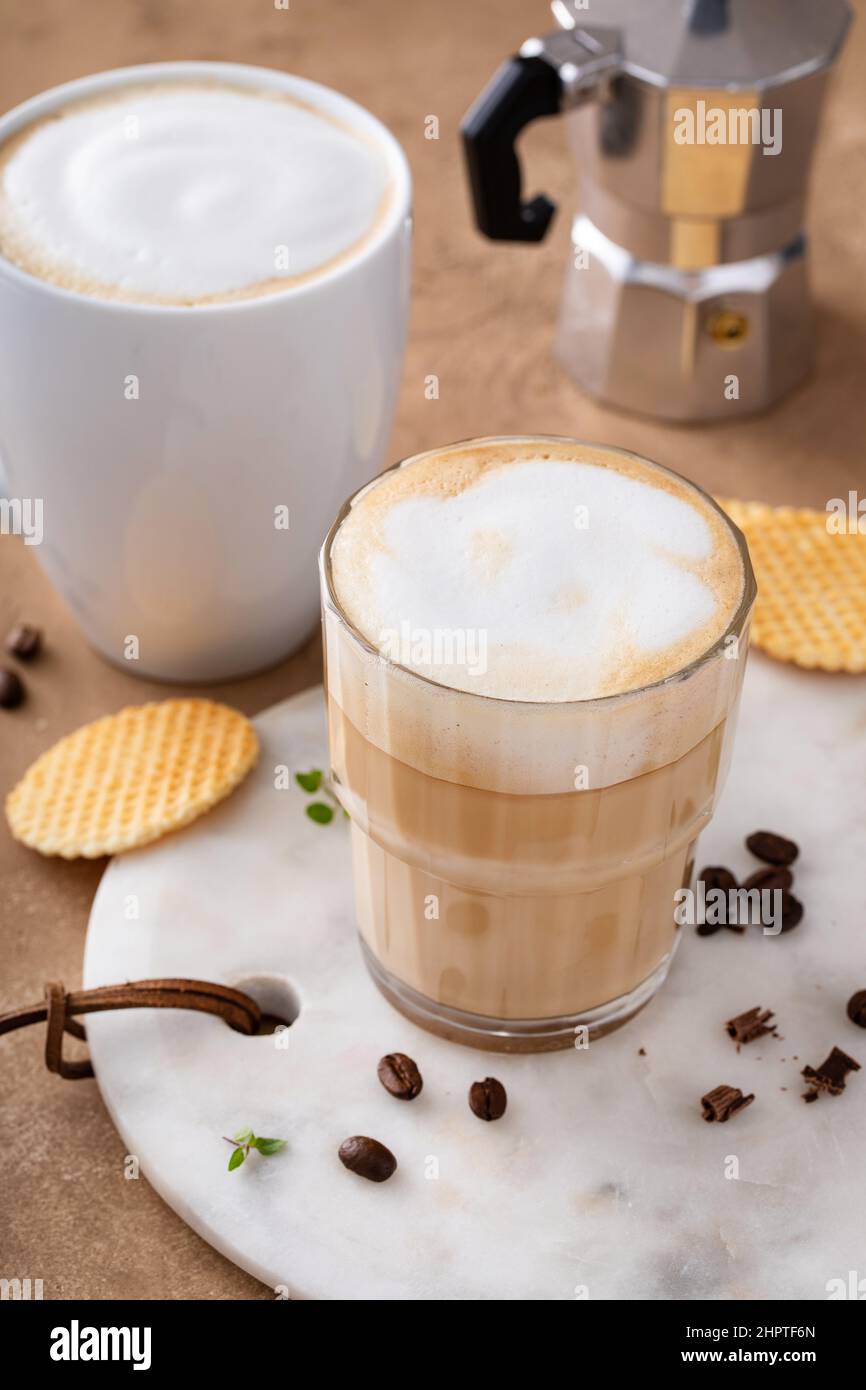Hot coffee latte and cappuchino in a glass and mug Stock Photo - Alamy