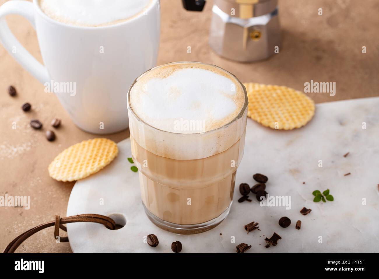 Hot coffee latte and cappuchino in a glass and mug Stock Photo - Alamy