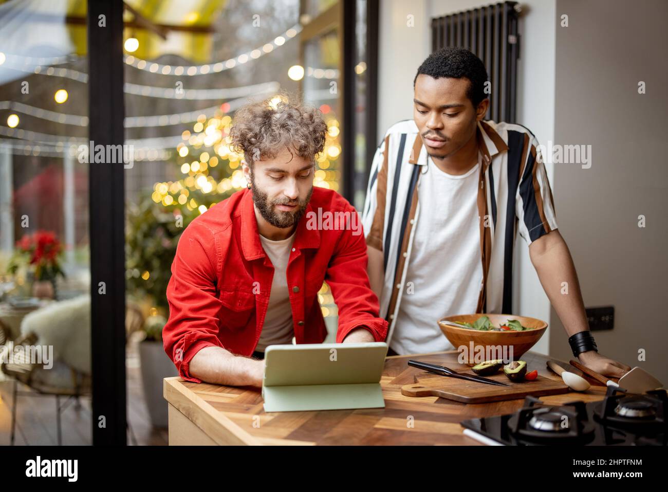 Two guys watching movie together on digital tablet at home Stock Photo ...