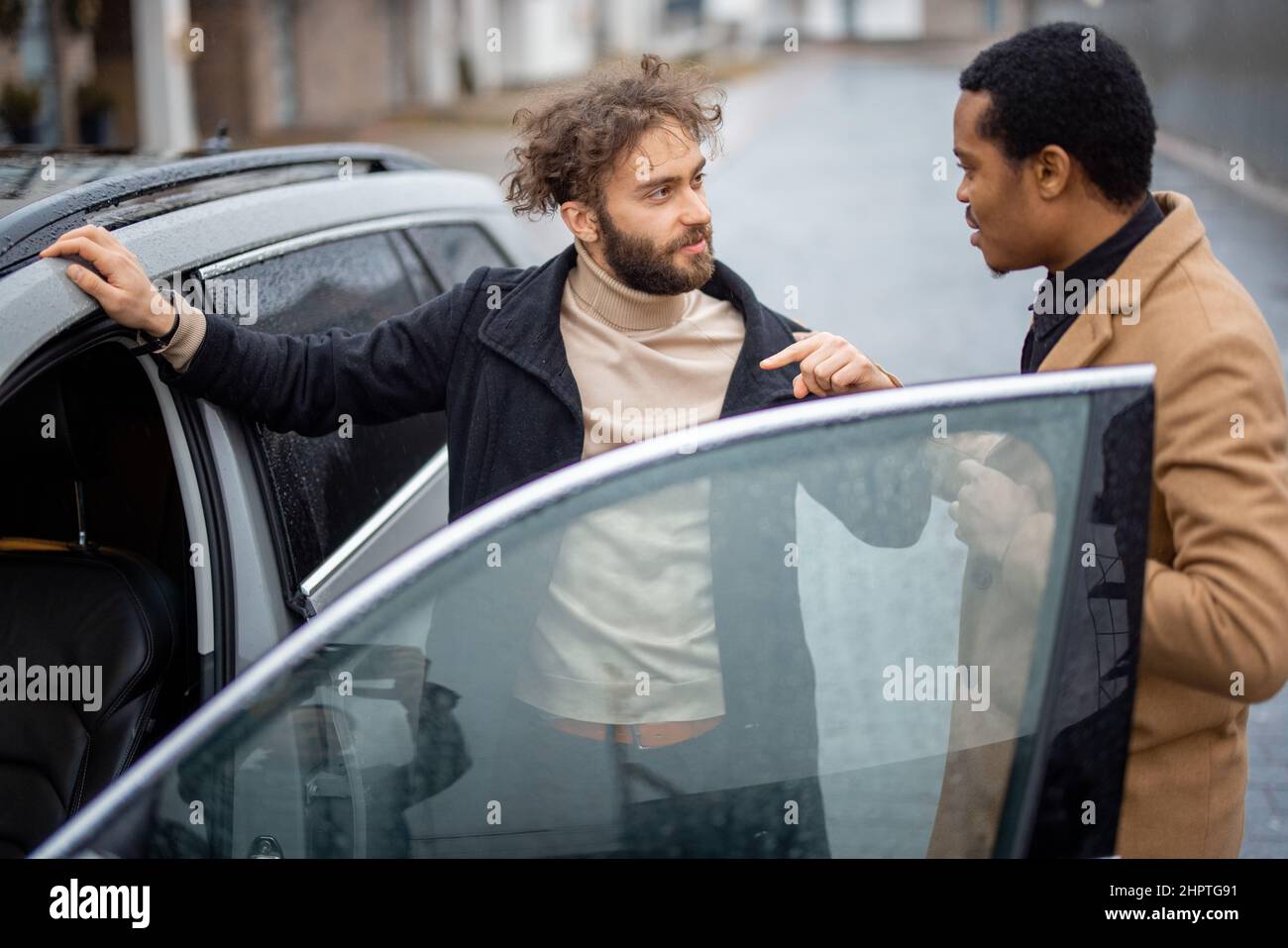 Two men standing car hi-res stock photography and images - Alamy