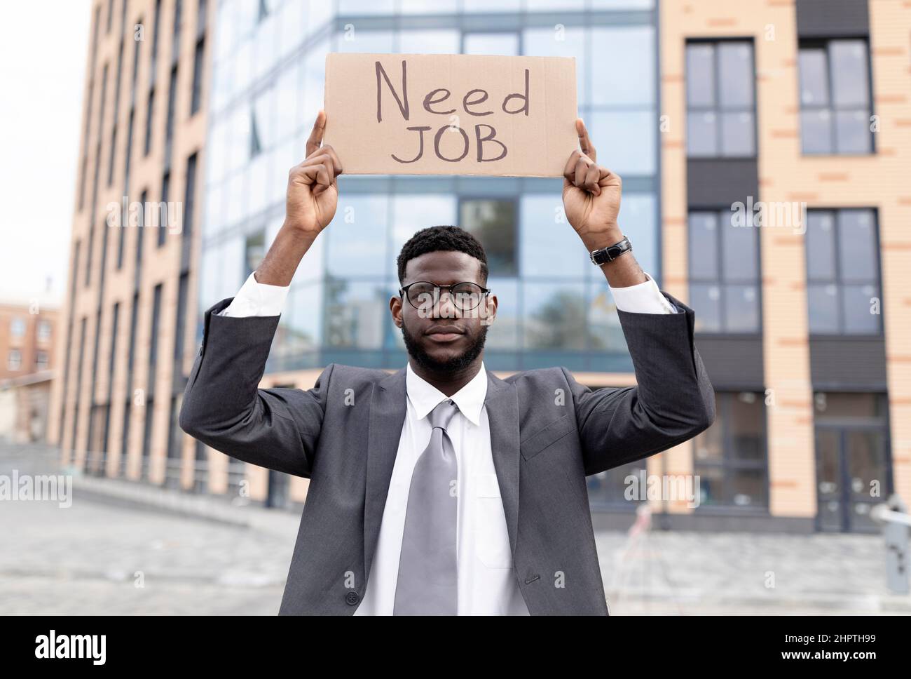Need job concept. African american office worker holding poster while ...