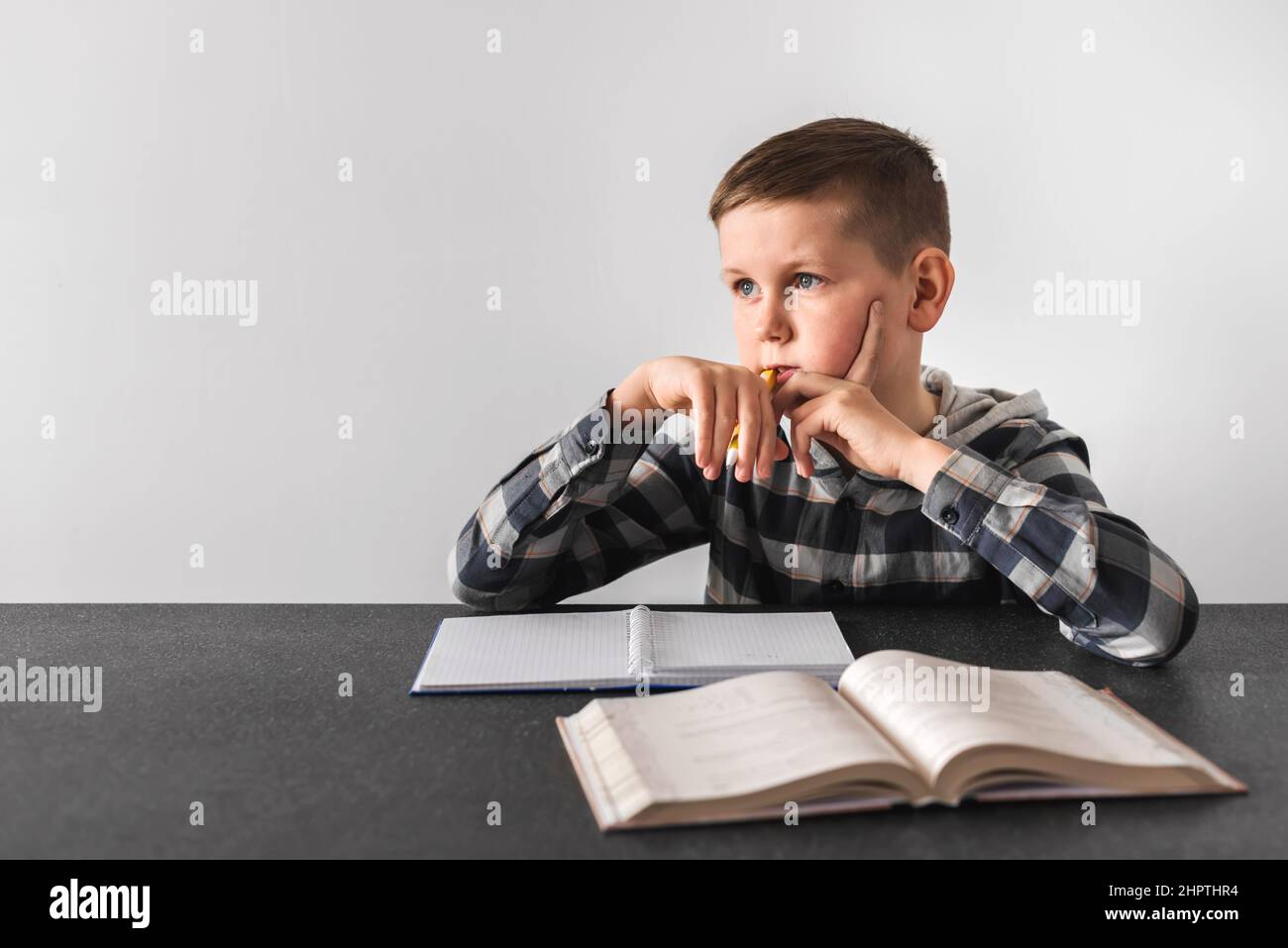 School Boy Thinking and Doing Homework Stock Photo - Alamy