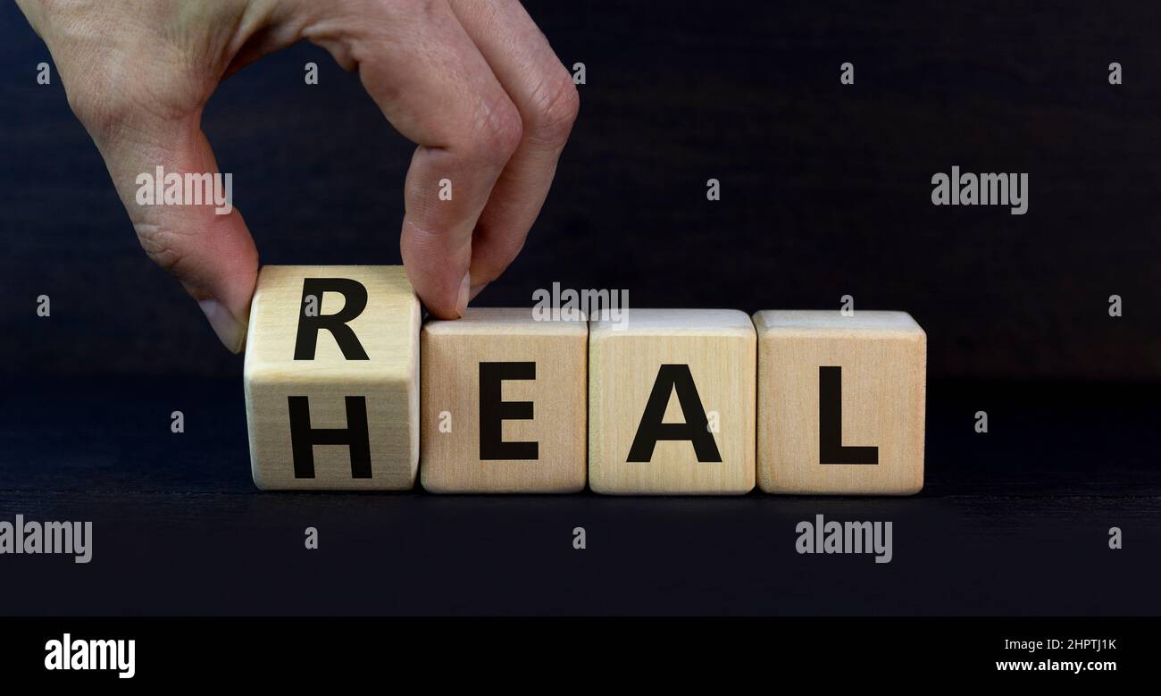 Real heal symbol. Fliped a wooden cube with words 'Real heal ...