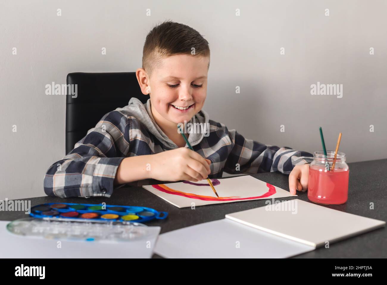 Boy Drawing Picture with Colorful Paints Stock Photo - Alamy