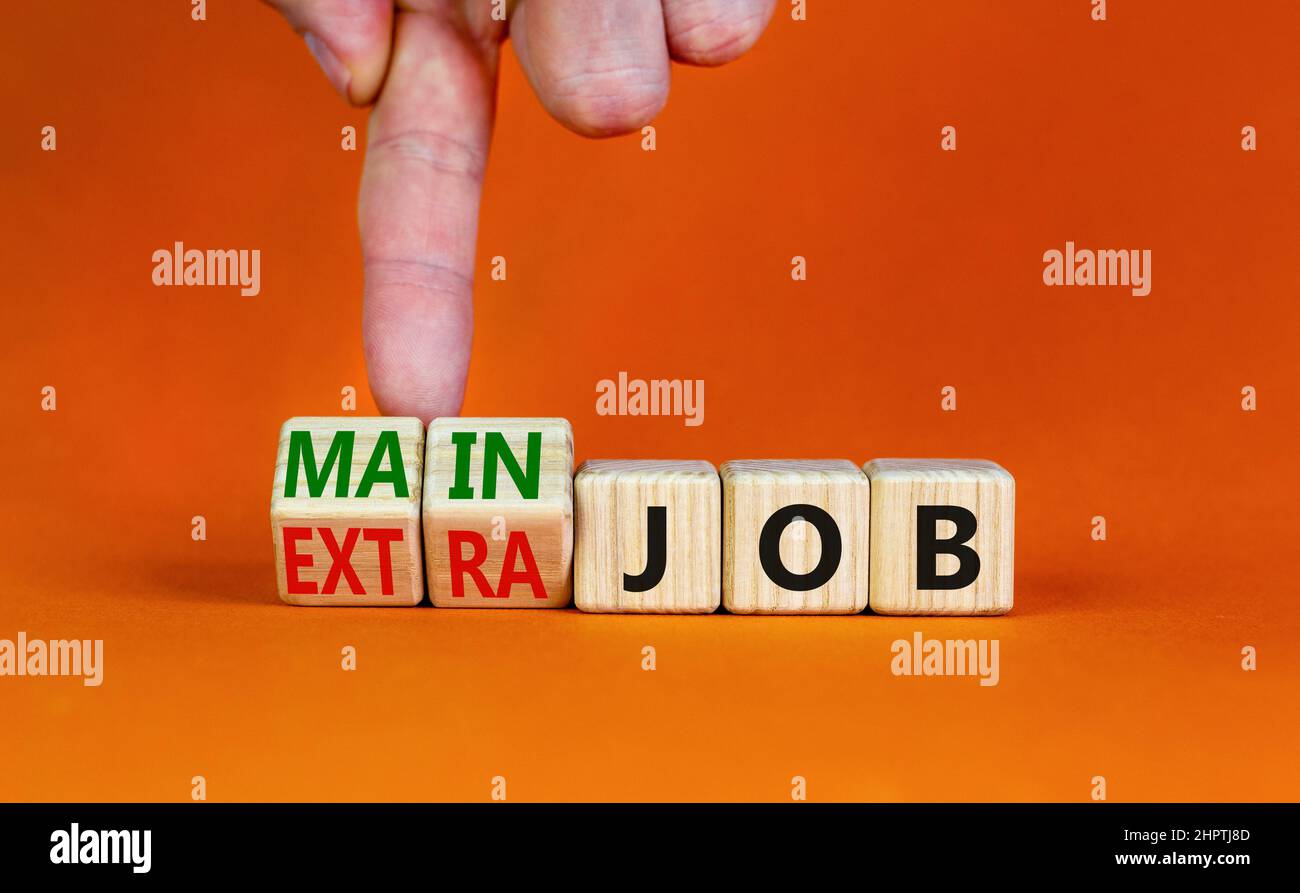 Extra or main job symbol. Businessman turns wooden cubes and changes ...