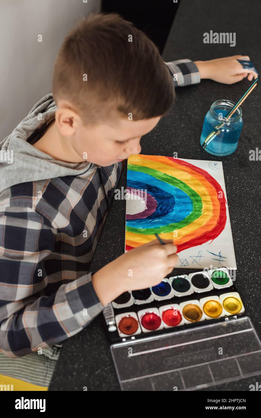 Kid Painting Rainbow Picture with Brushes Stock Photo - Alamy