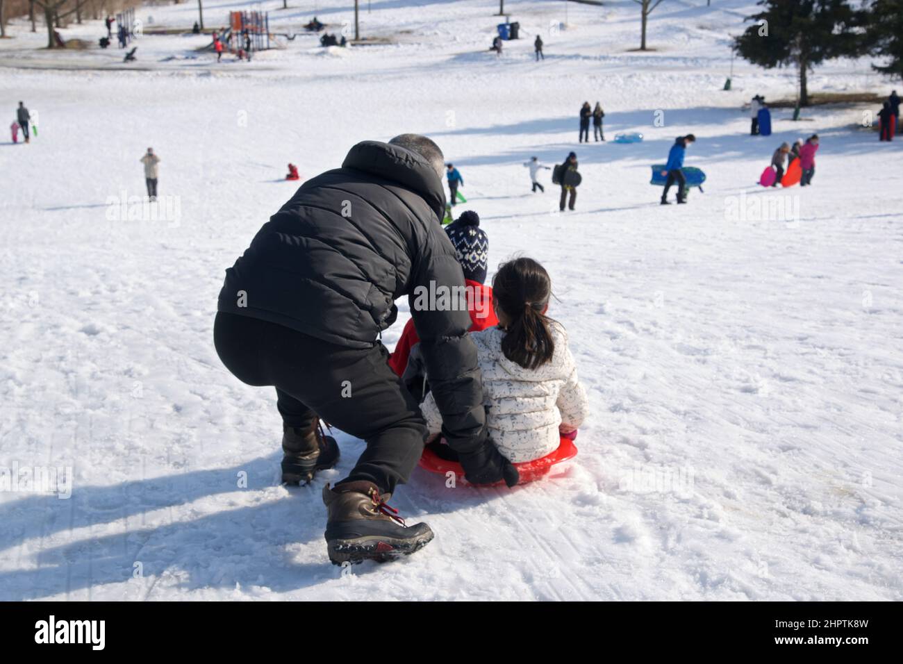 Winter sport toboggan - father and daughter playing toboggan, winter ...