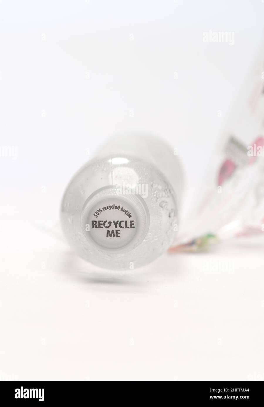 A single use bottle showing cap that has recycle me printed on to it ...