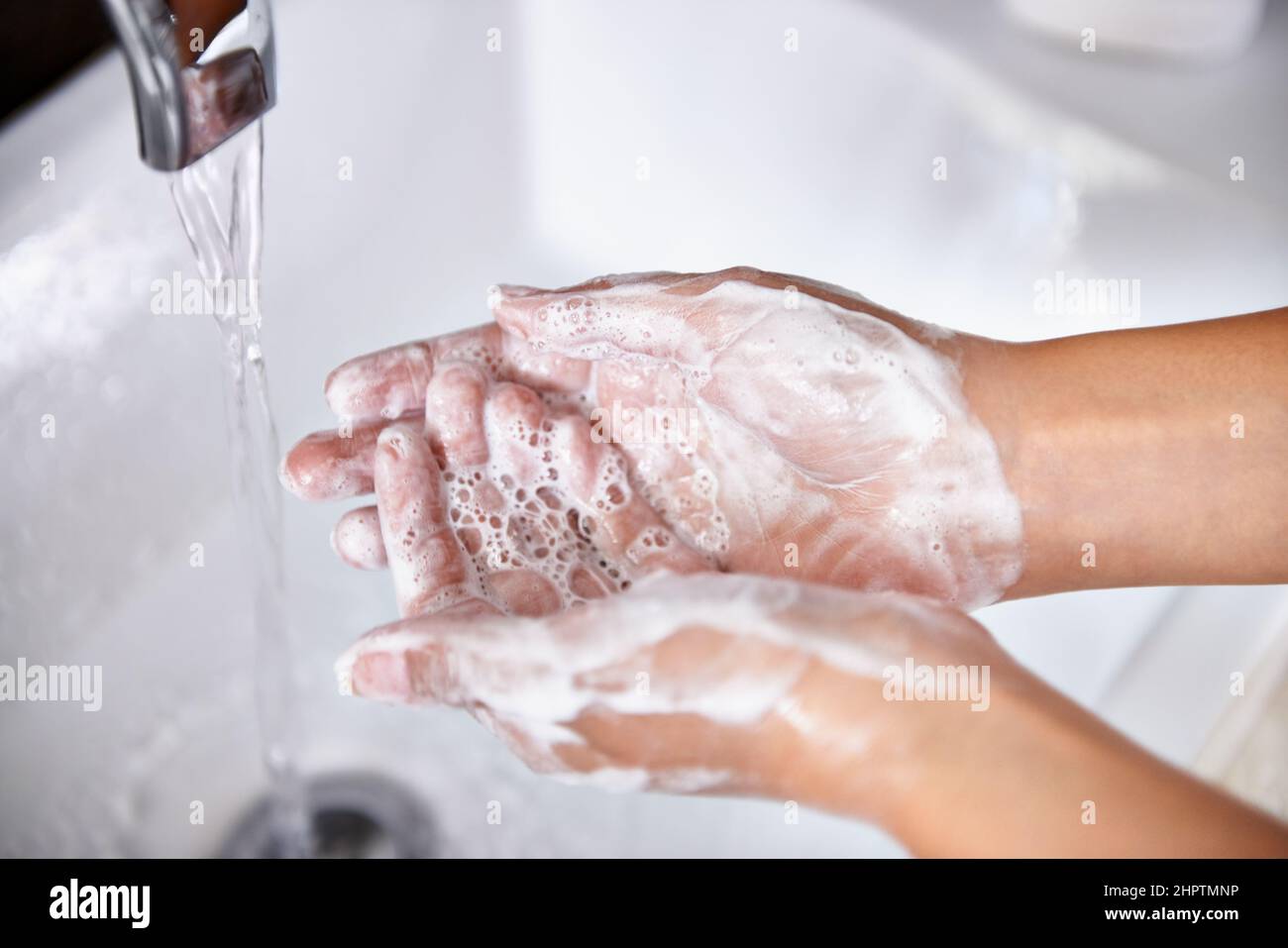 Good hygiene - a great habit. A cropped shot of a young woman washing ...