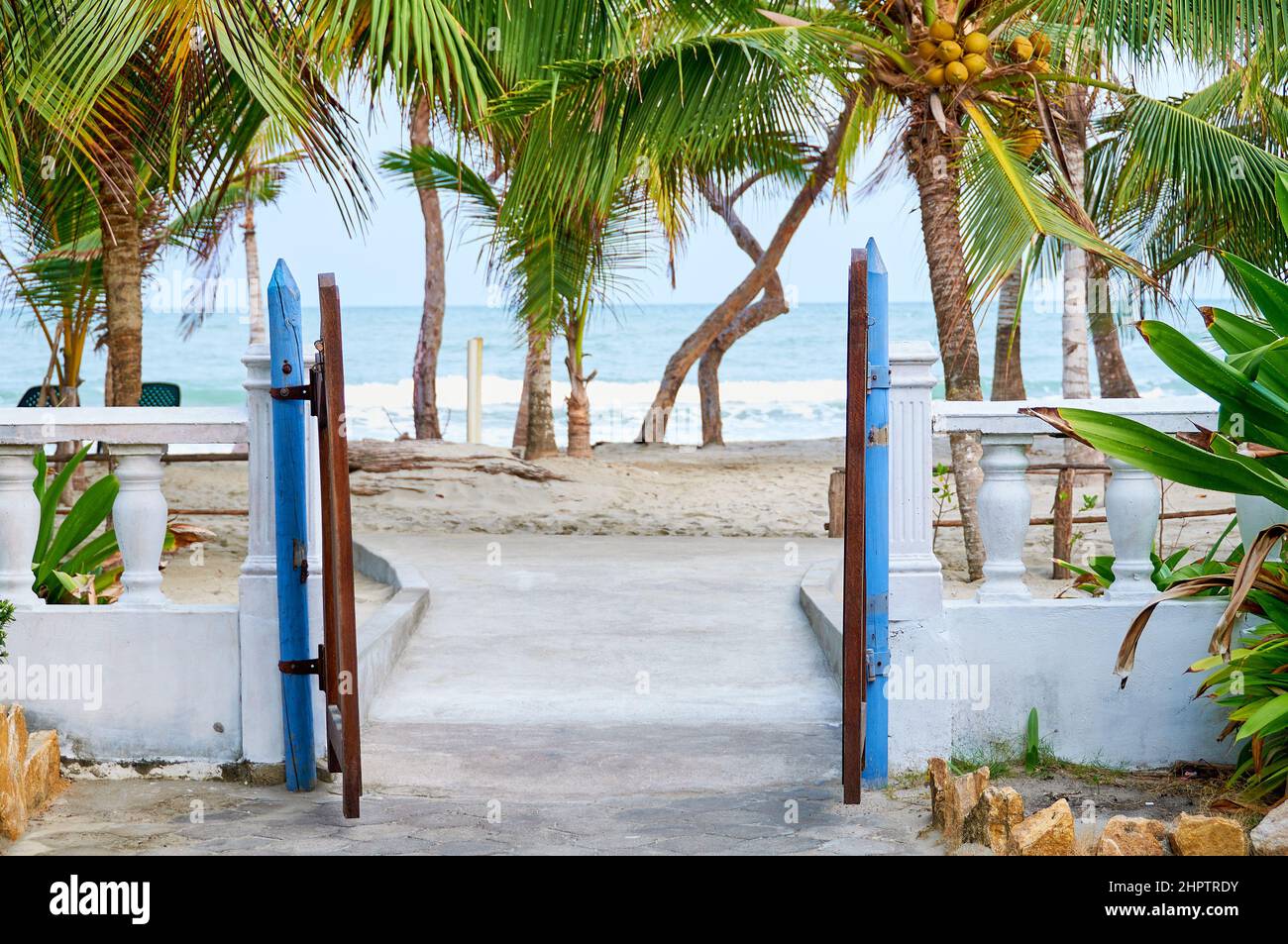 Open gate leading to the beautiful wavy ocean on the coast Stock Photo ...